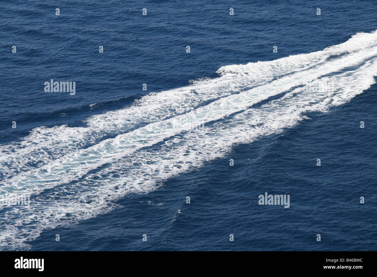 outboard motor speed boat trail in action in blue sea Stock Photo - Alamy