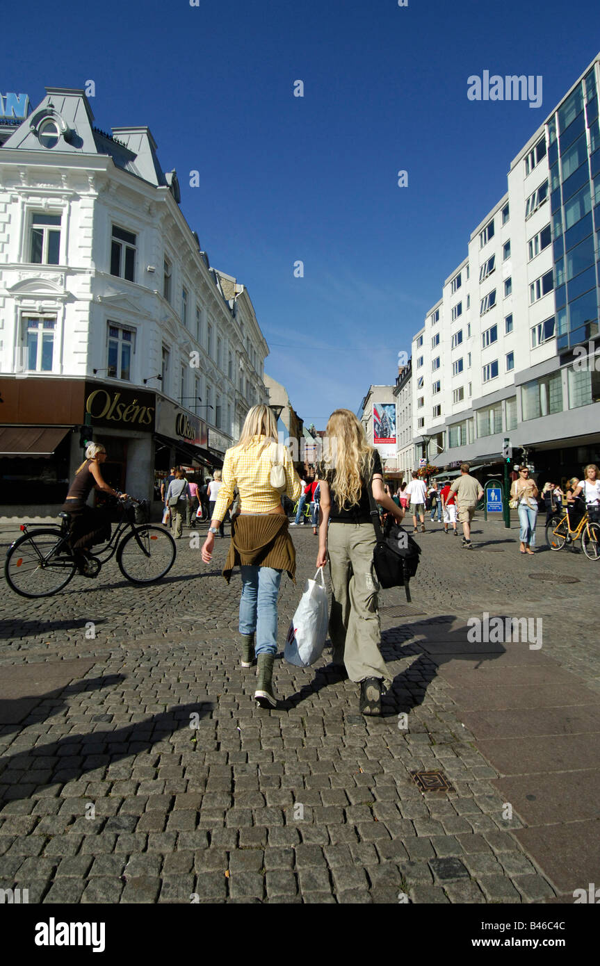 Two scruffily dressed young blond women walking down a pedestrian ...