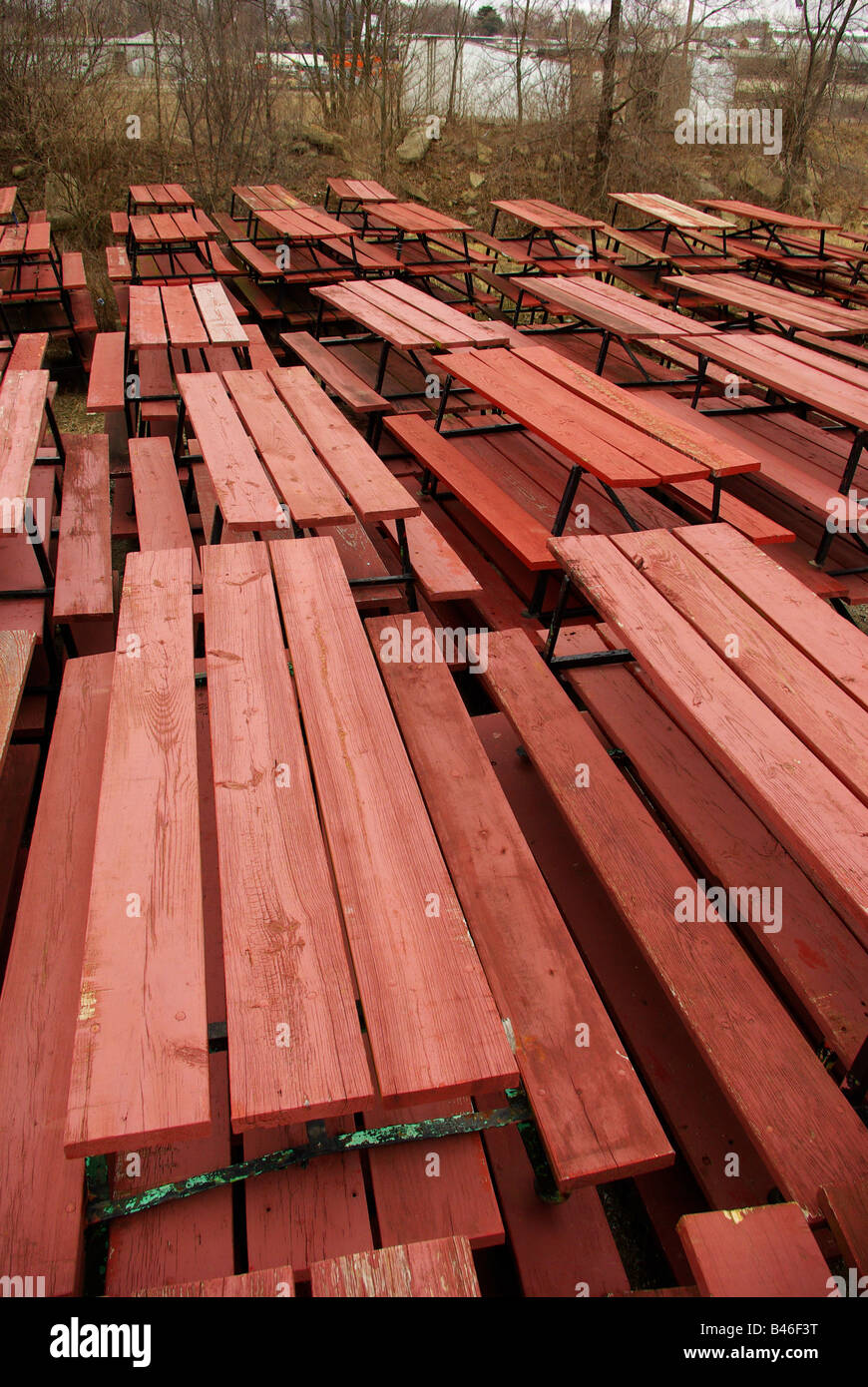 Many park benches are stacked and left to the elements in this little ...