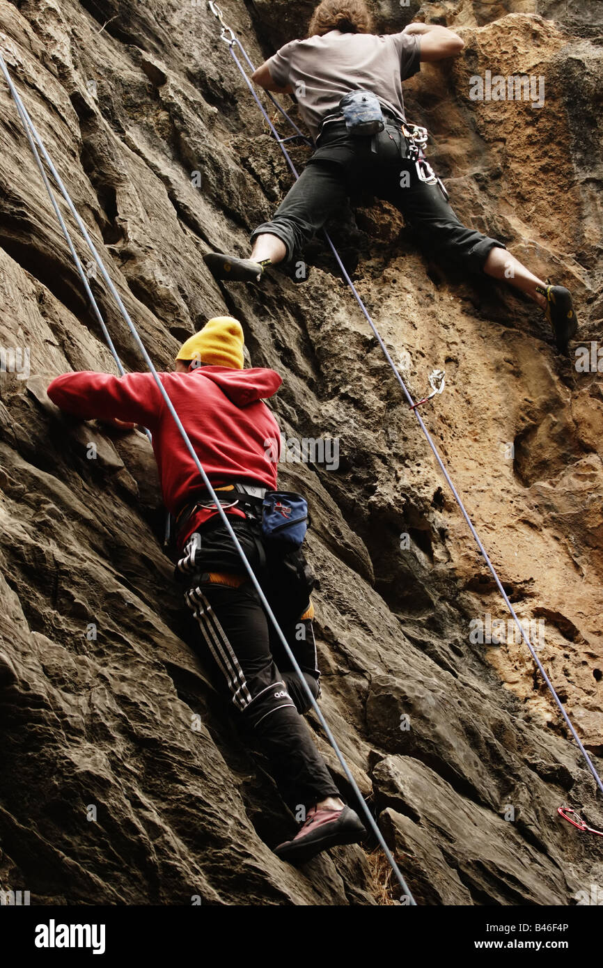 Two rock climbers scaling a near vertical cliff wall in Nepal Stock ...