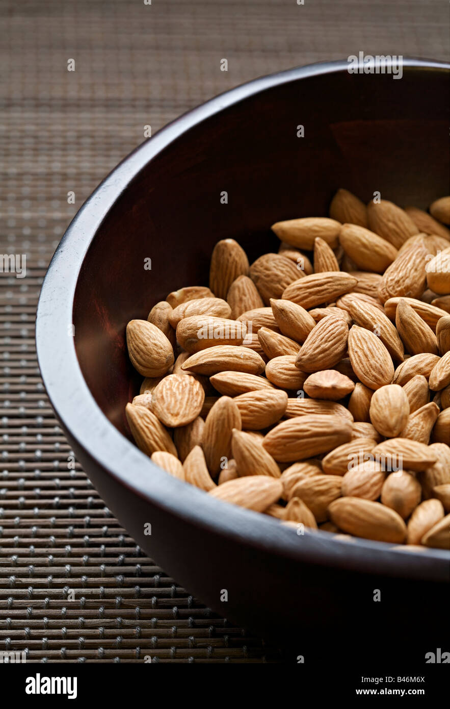 Organic raw almonds in a wooden bowl Stock Photo - Alamy