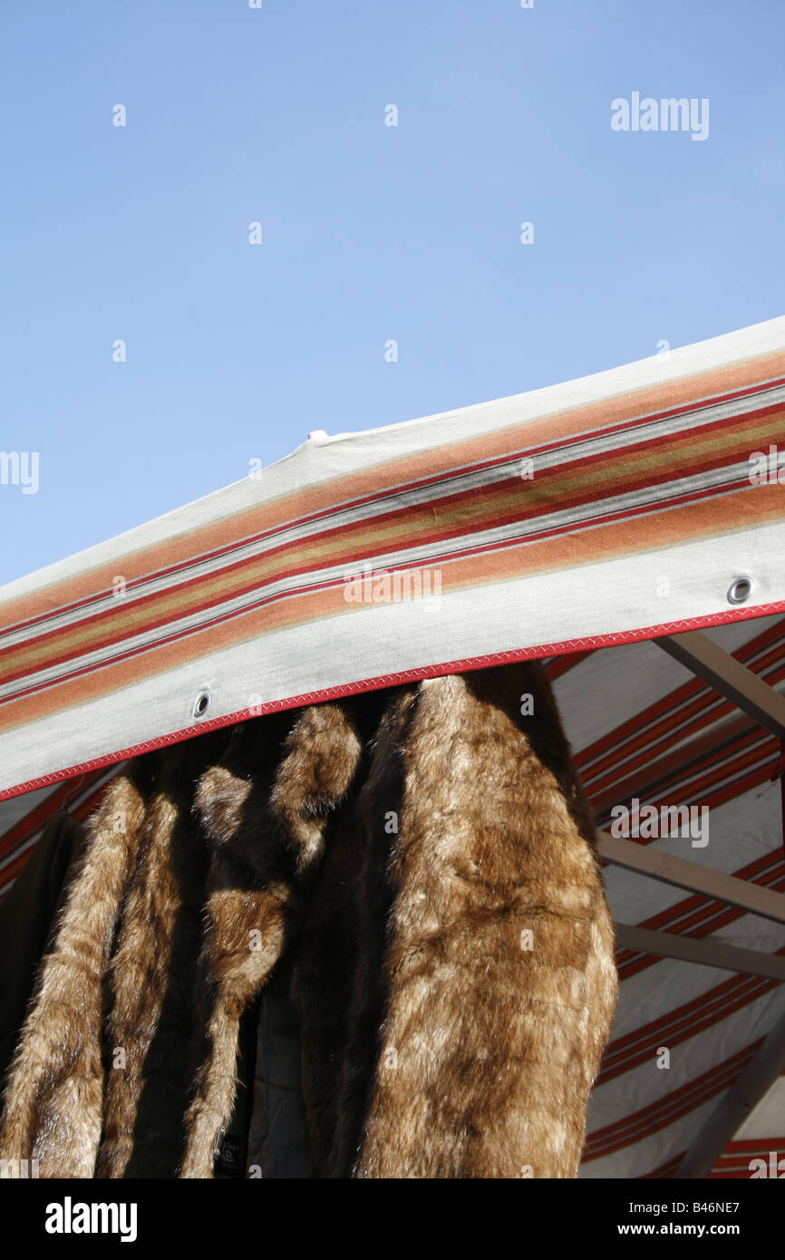 fur coat for sale on market stall stand Stock Photo - Alamy