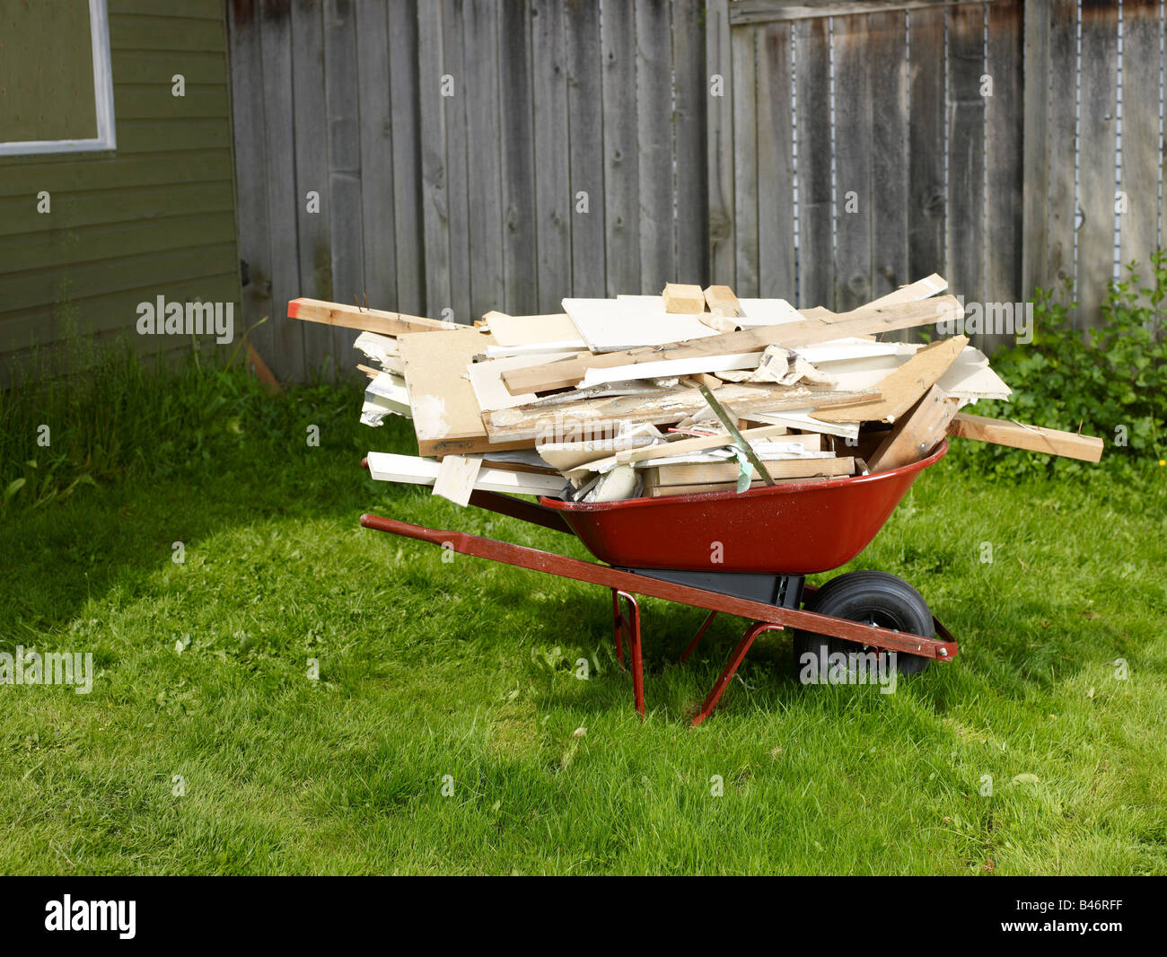 Wheelbarrow Full of Junk in Backyard Stock Photo - Alamy