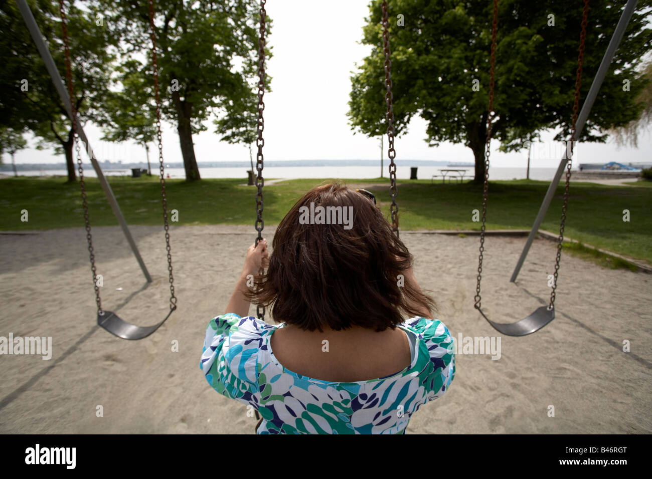 Woman Sitting on Swing Stock Photo - Alamy