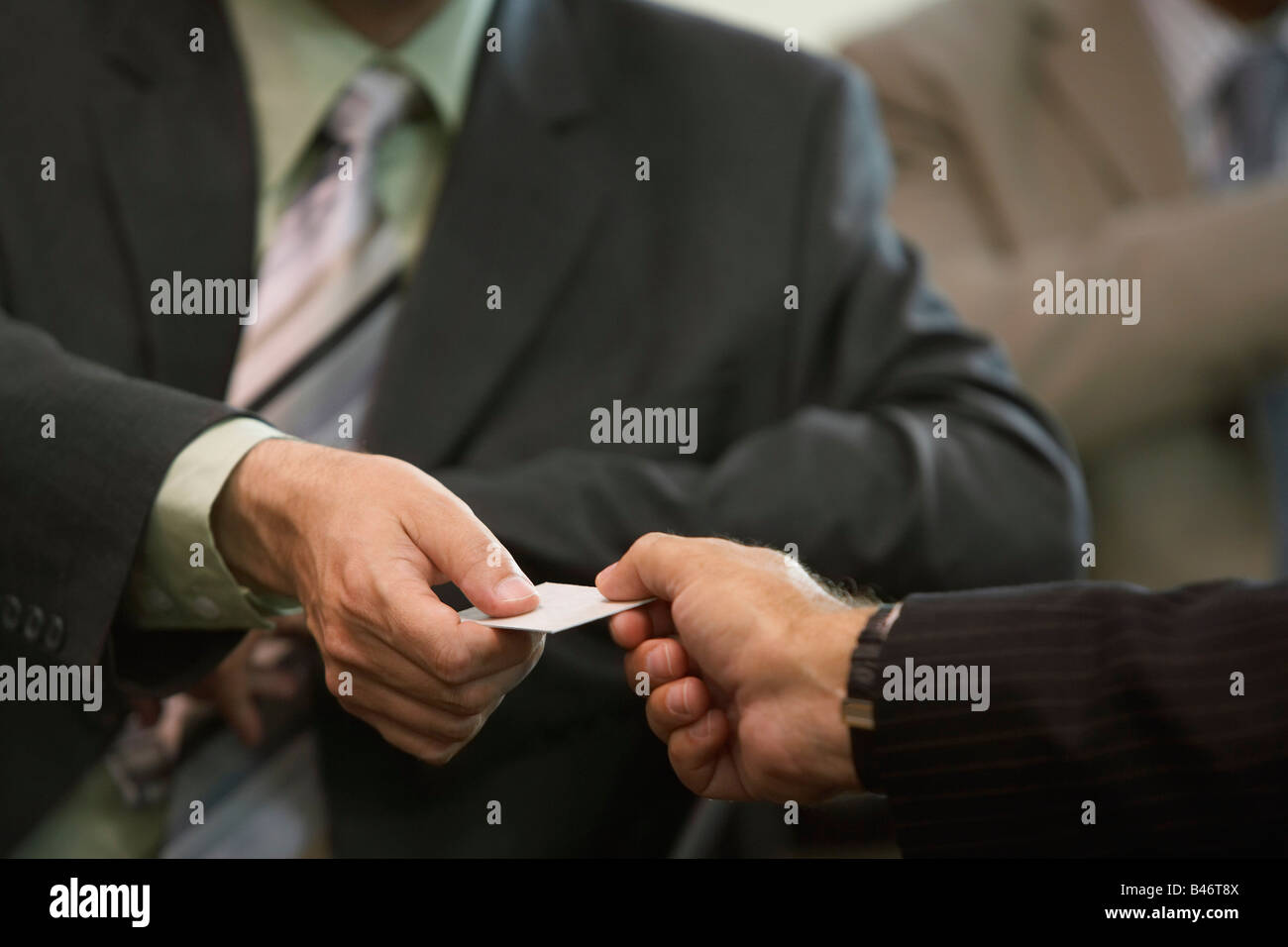 Two businessmen exchanging business card hi-res stock photography and ...