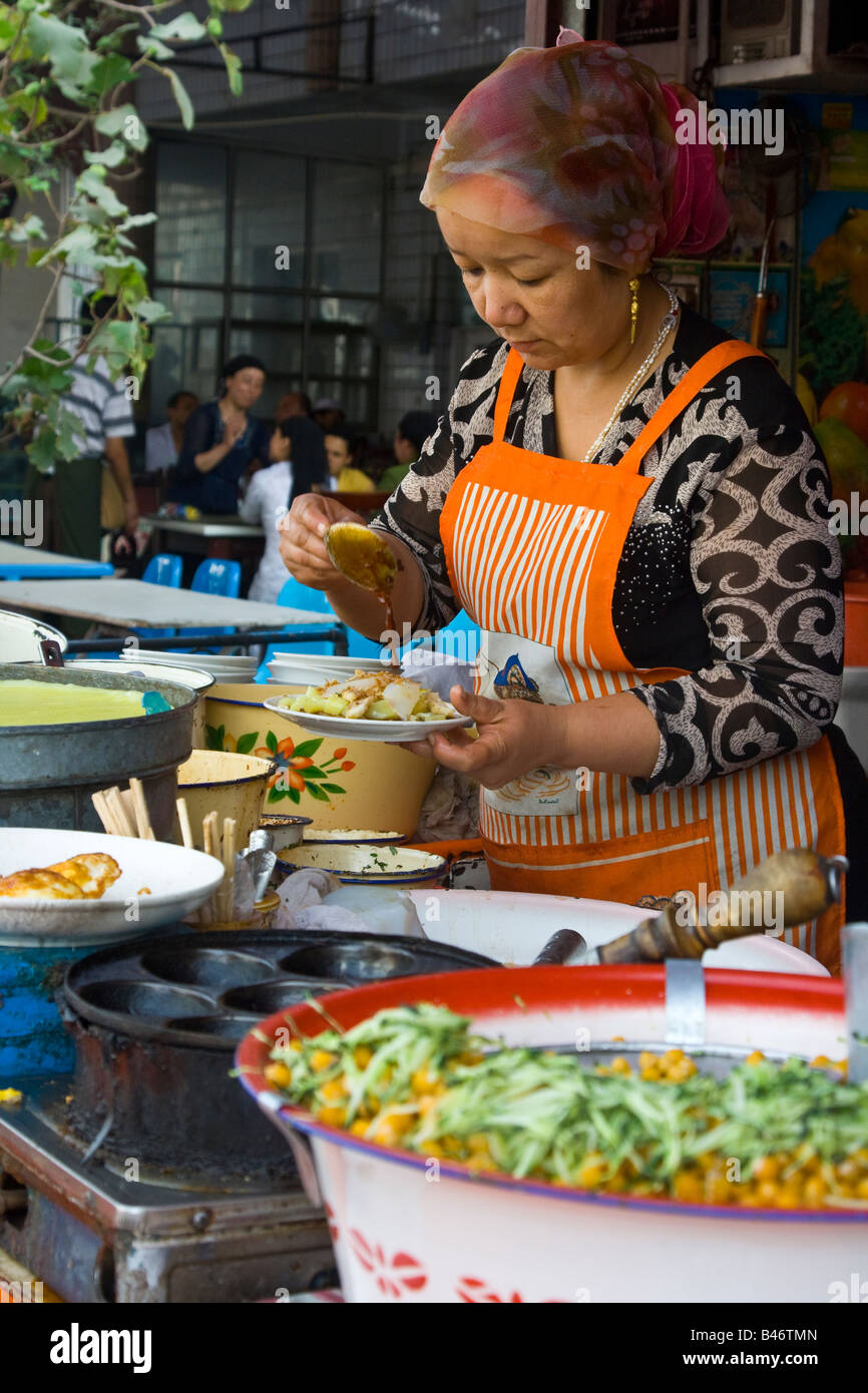 Uyghur Woman Making Food in the Sunday Marrket in Kashgar in Xinjiang ...