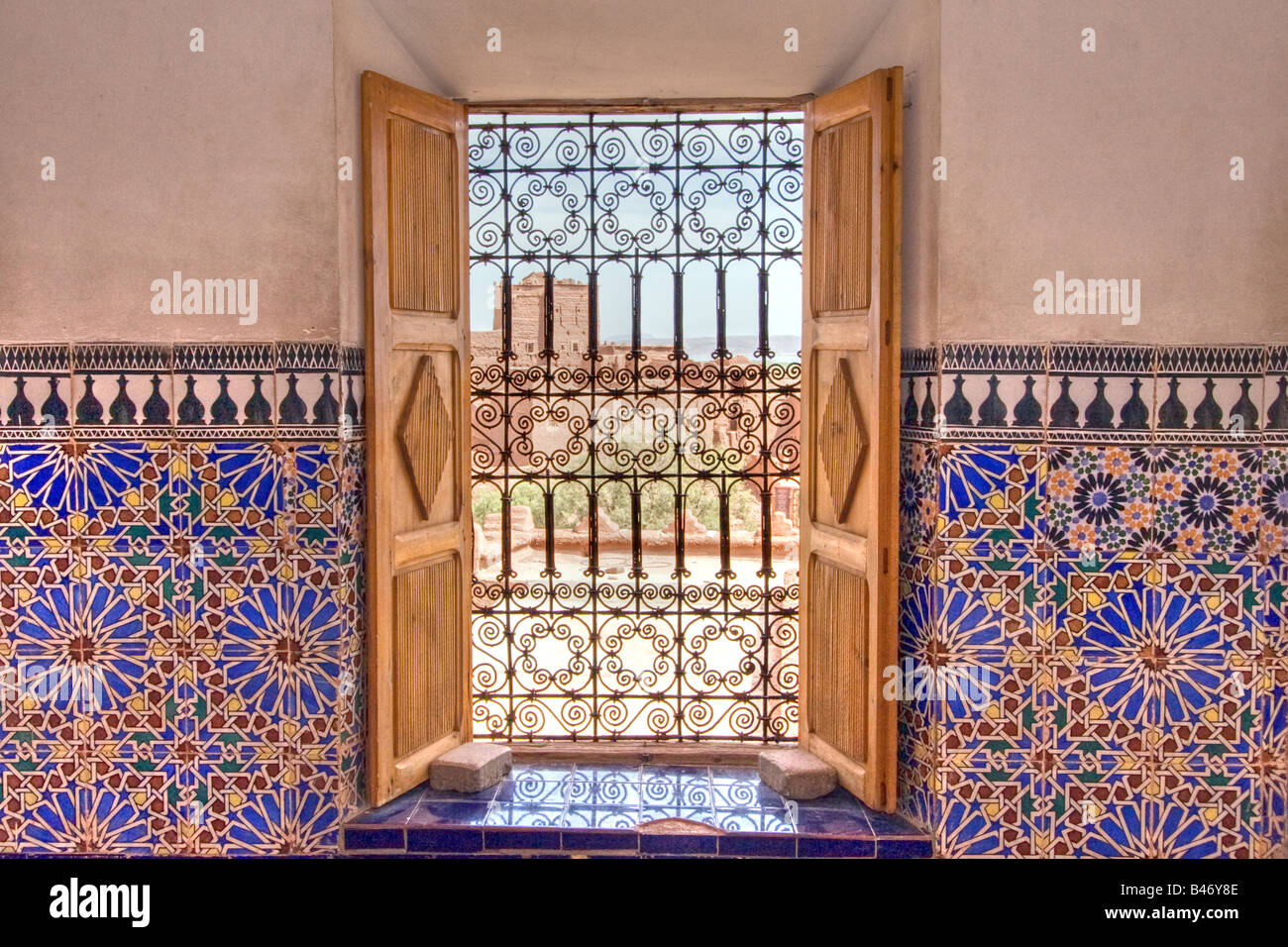 decorated window with mosaics and outside view on kasbah ouarzazate ...