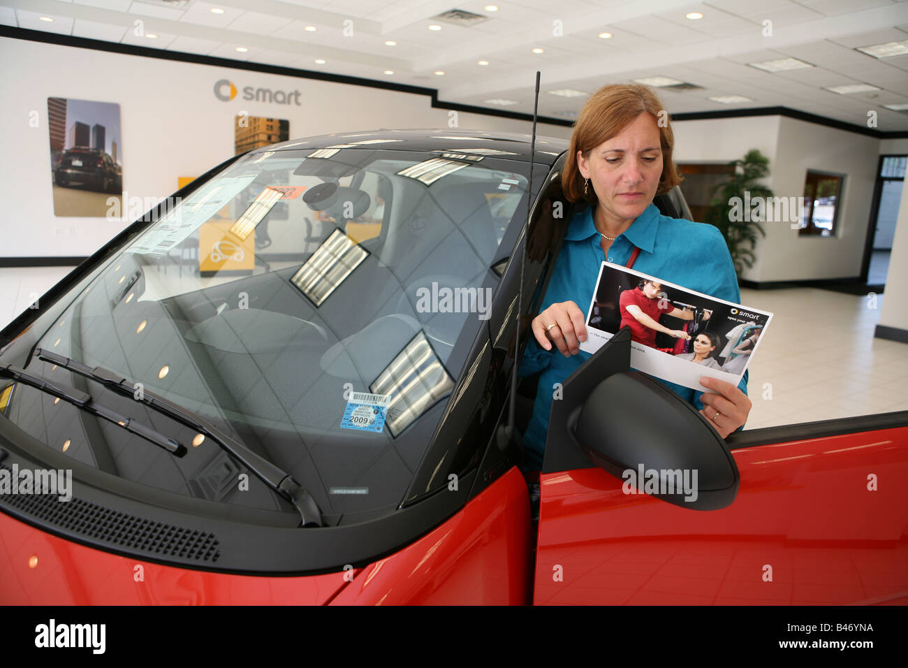 Woman considering purchasing the Smart Car Fortwo by Daimler Chrysler ...