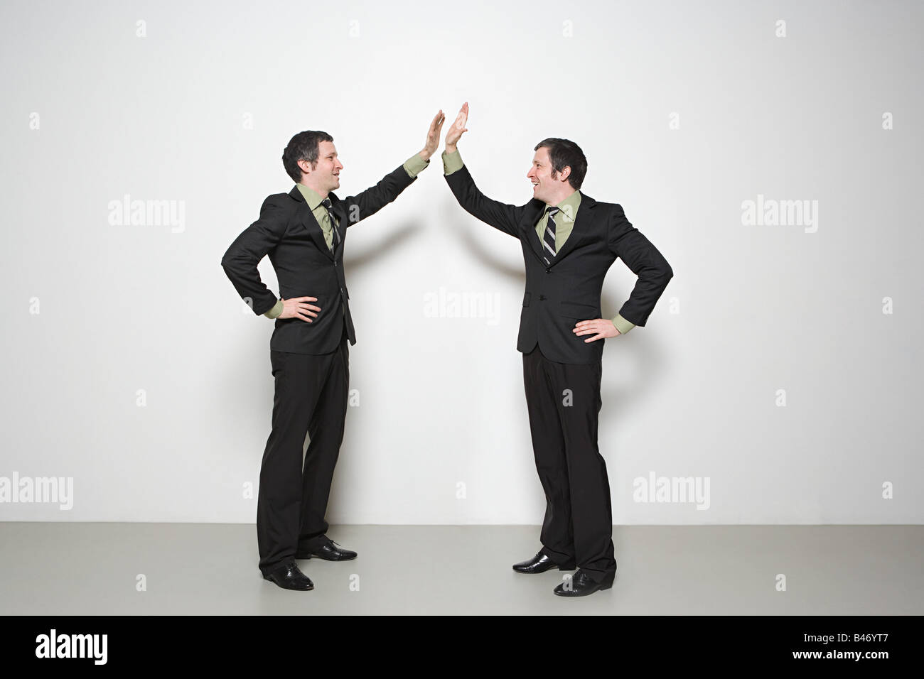 Men doing high five Stock Photo - Alamy