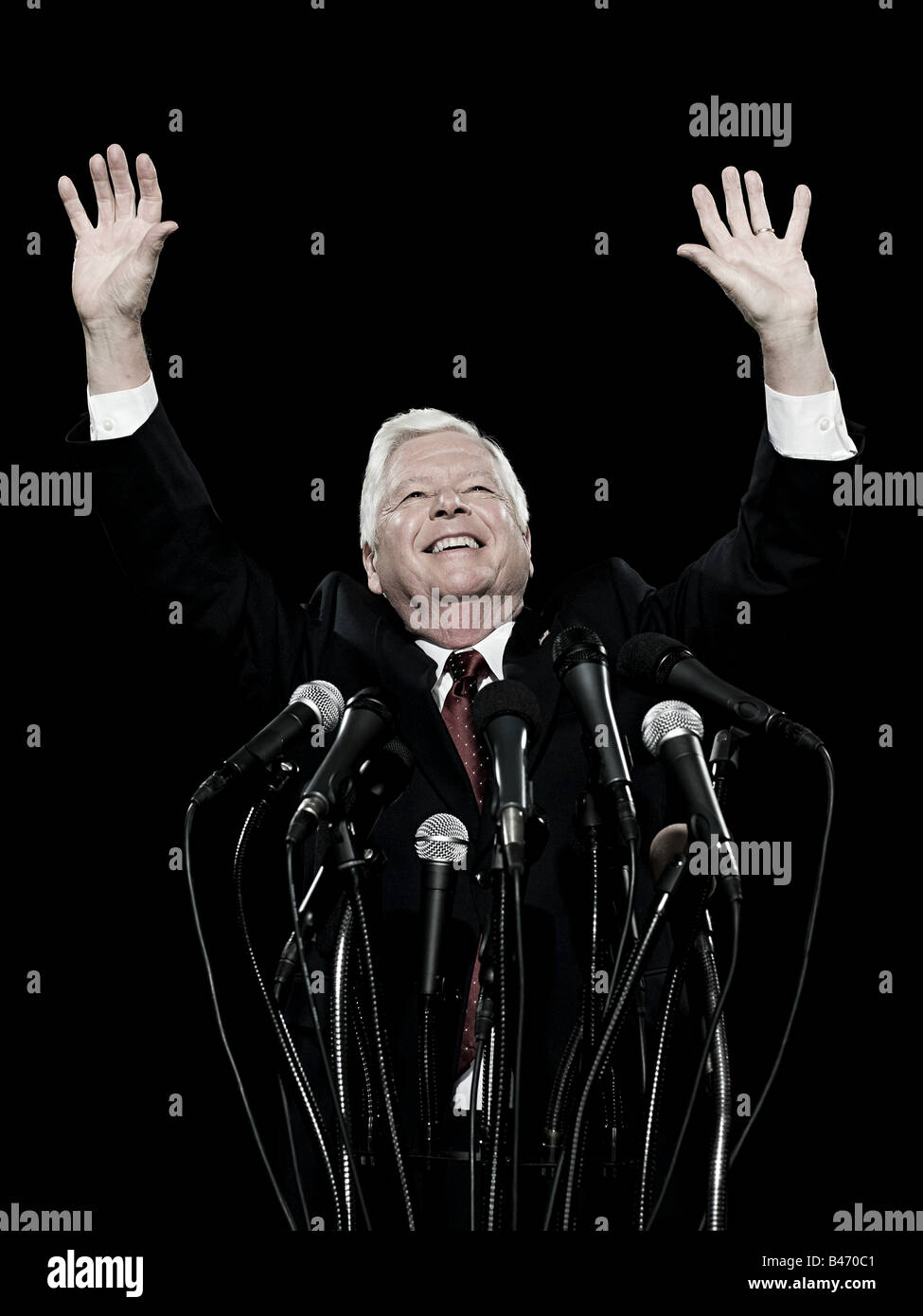 Politician with hands raised Stock Photo - Alamy