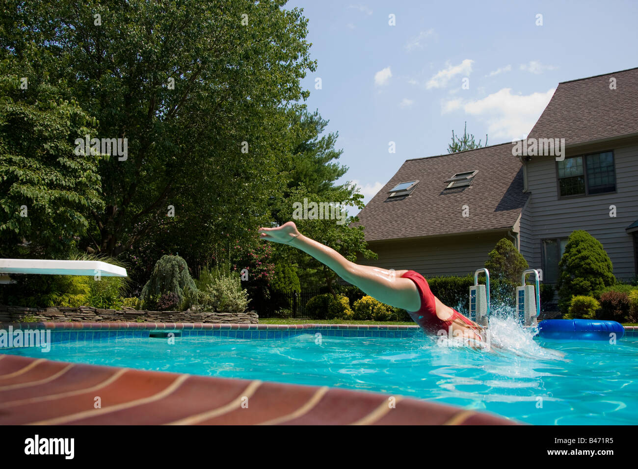 Child diving into a backyard swimming pool Stock Photo - Alamy