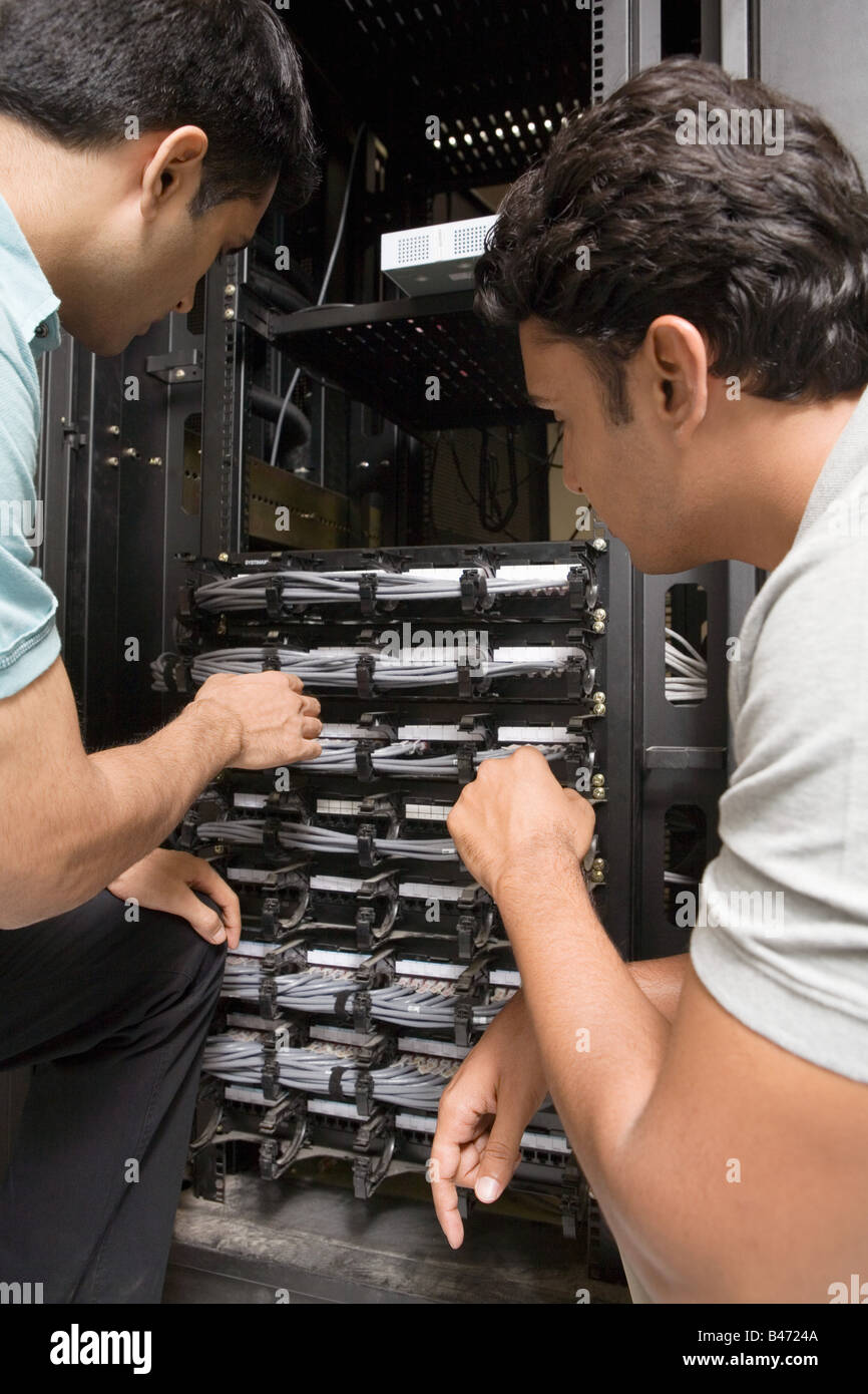Two computer technicians working on server Stock Photo - Alamy