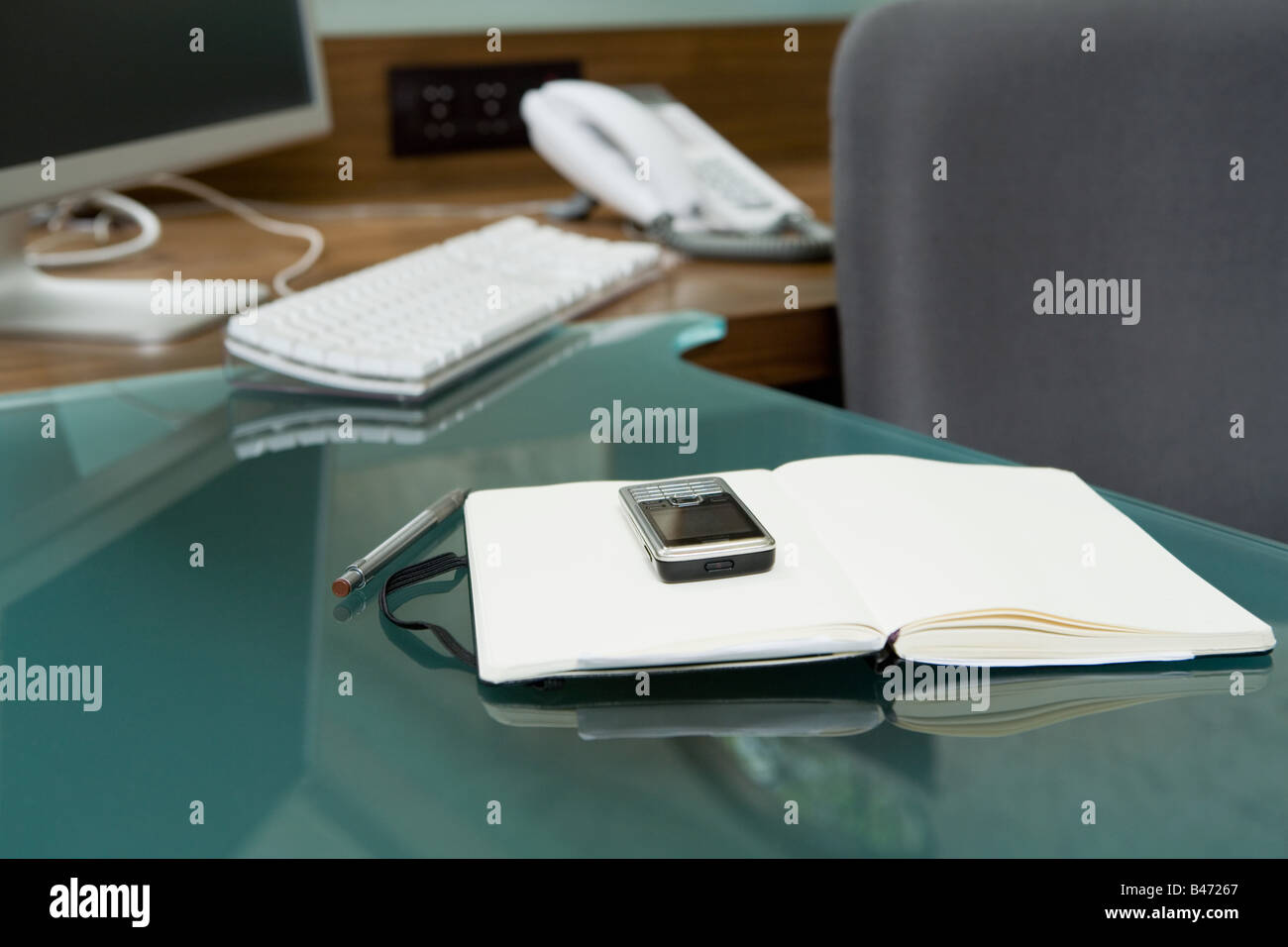 Cellular phone and notepad Stock Photo - Alamy