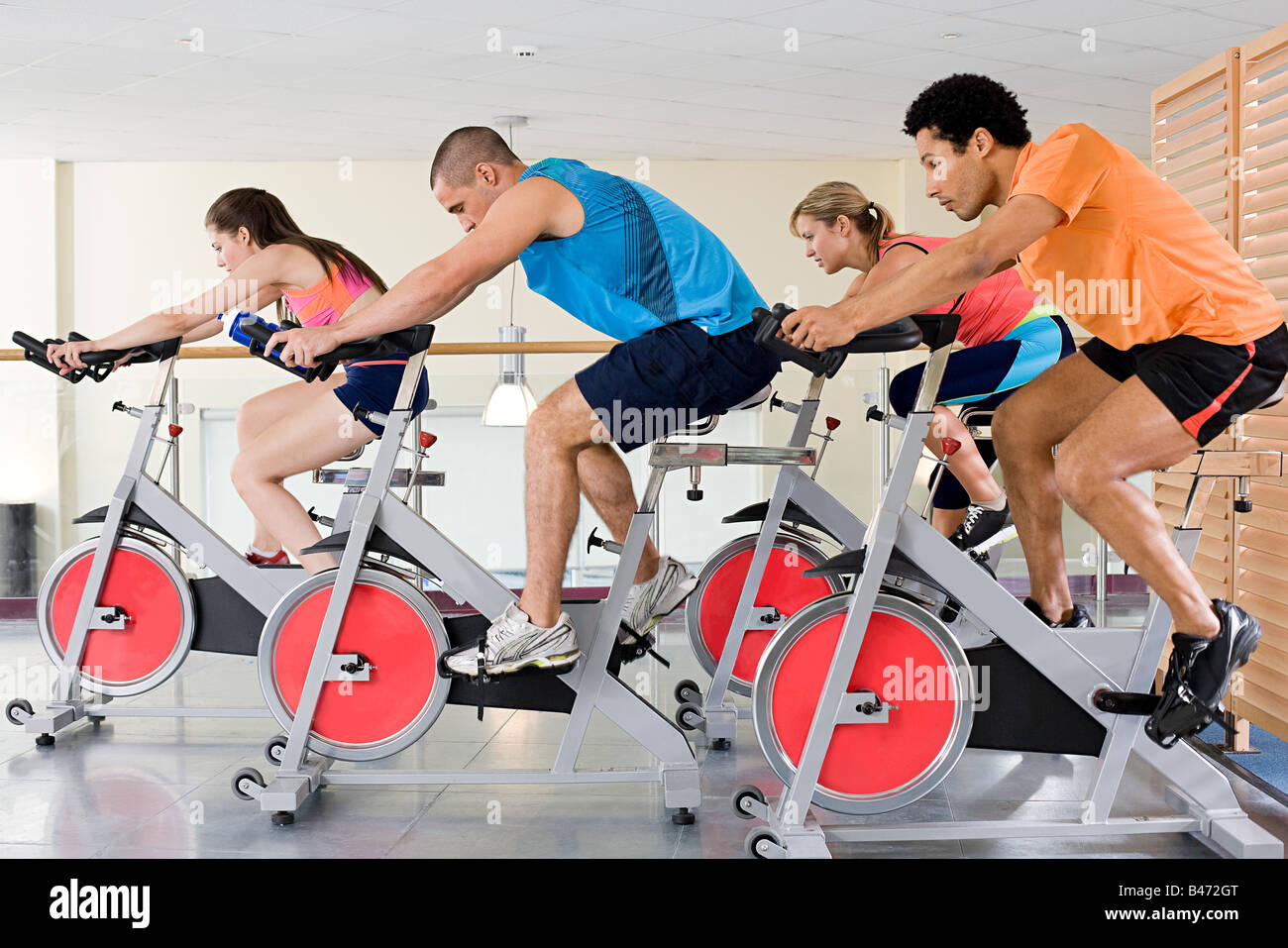 People on exercise bikes Stock Photo - Alamy