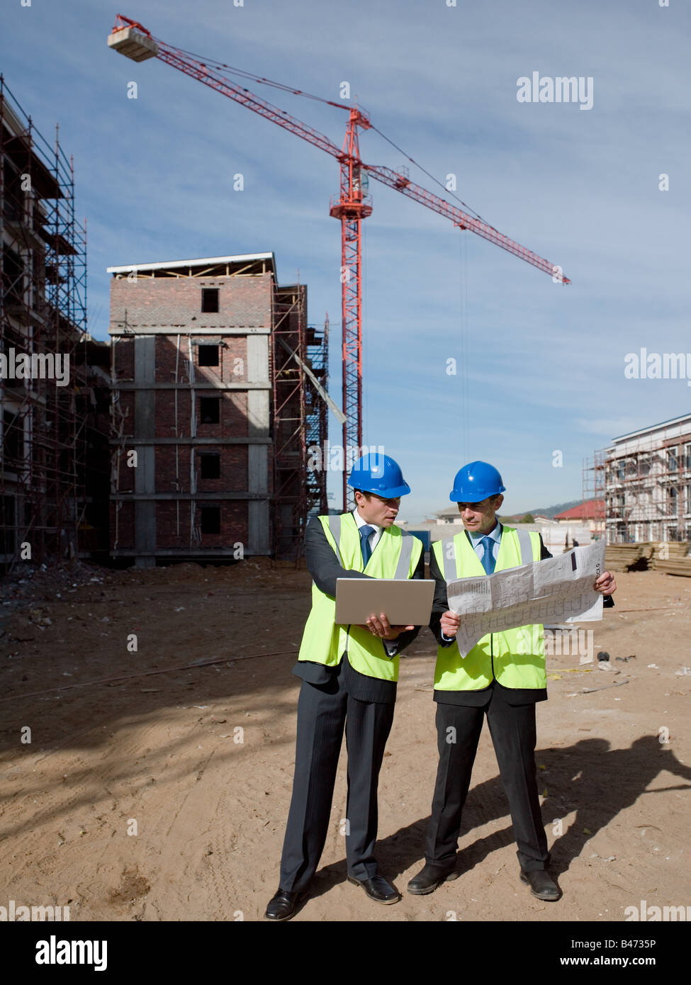 Engineers discussing paper blueprint machine hi-res stock photography ...