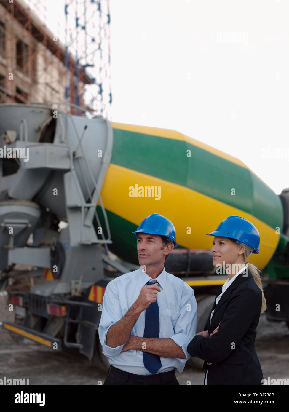 Engineers by cement mixer Stock Photo - Alamy