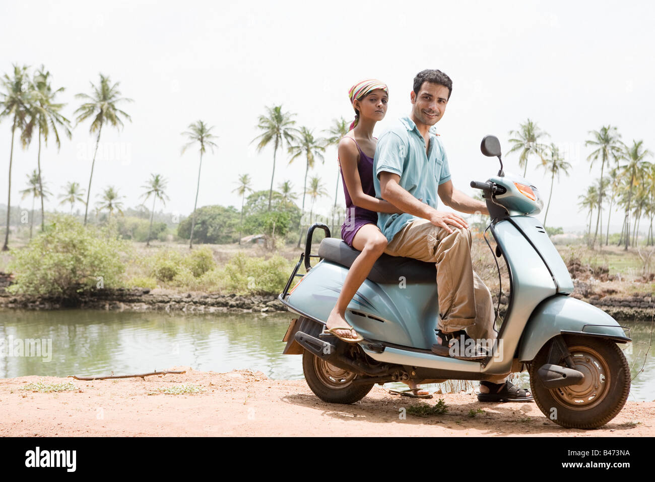 Couple on a moped Stock Photo - Alamy
