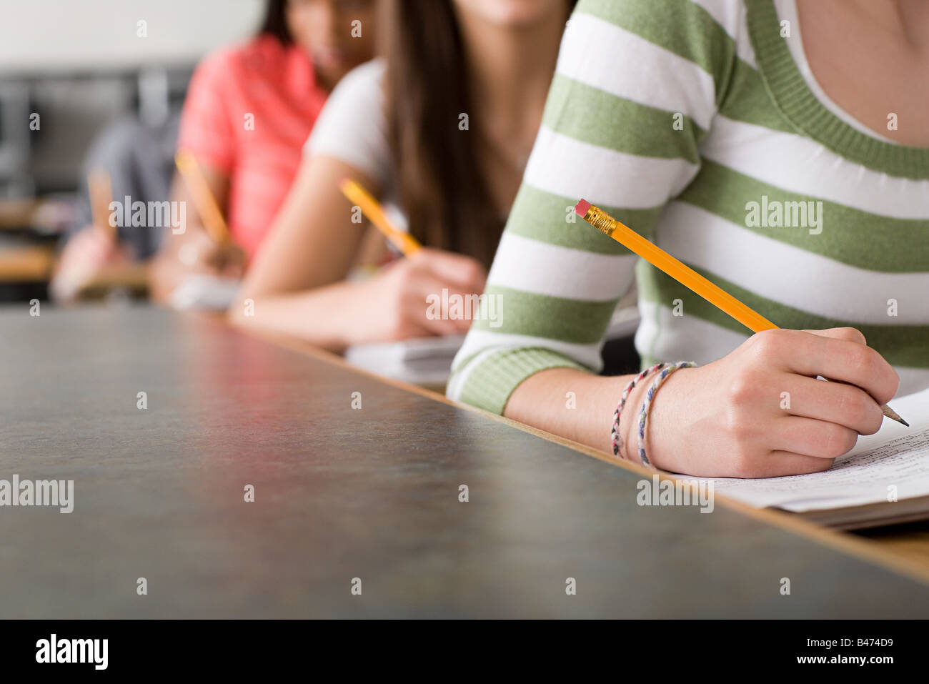 High school students writing Stock Photo - Alamy
