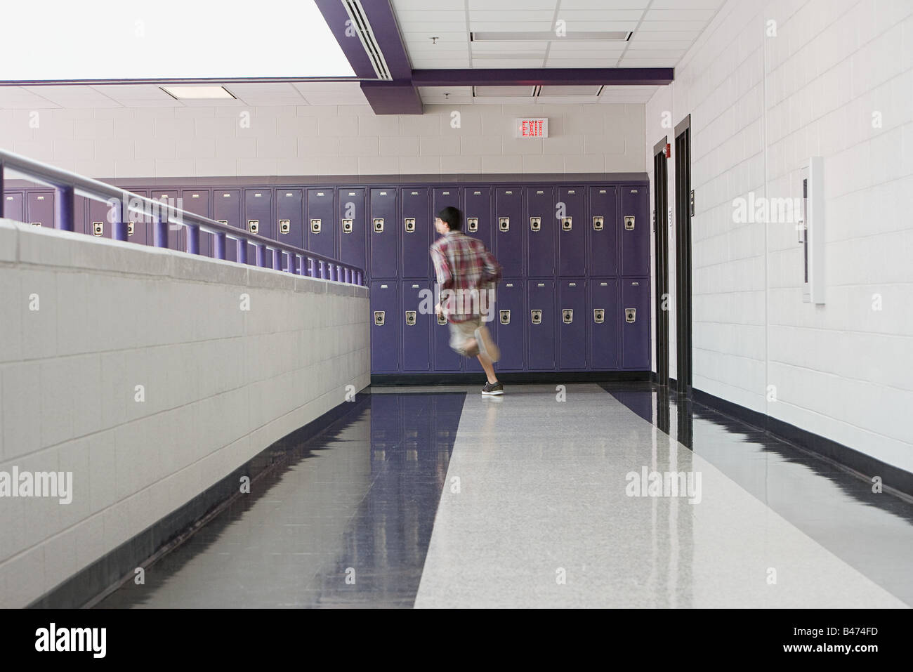 A male high school student running in a corridor Stock Photo - Alamy