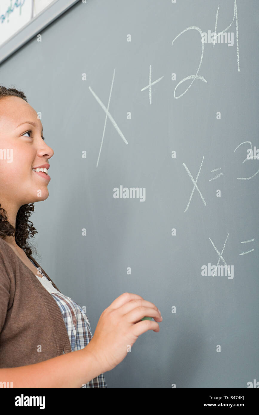 A student looking at a sum on a blackboard Stock Photo - Alamy