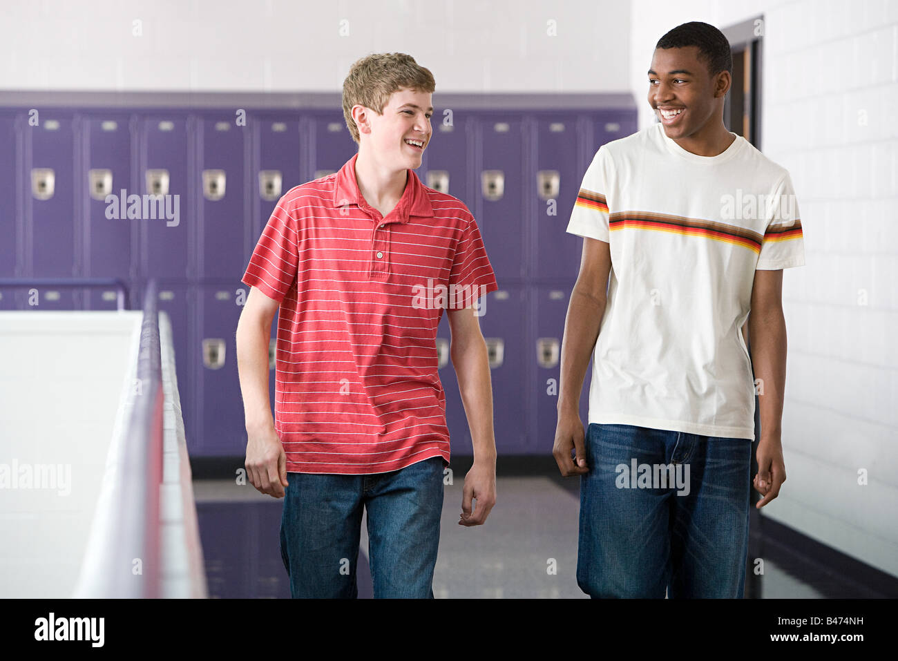Friends in school corridor Stock Photo - Alamy