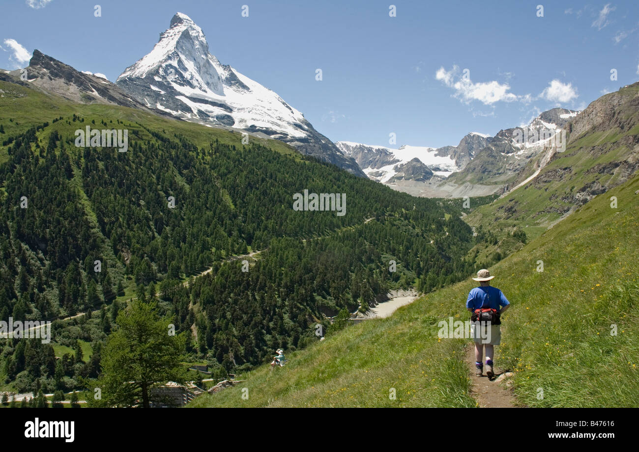 Walking in the stunning alpine scenery of the Zmutt valley above ...
