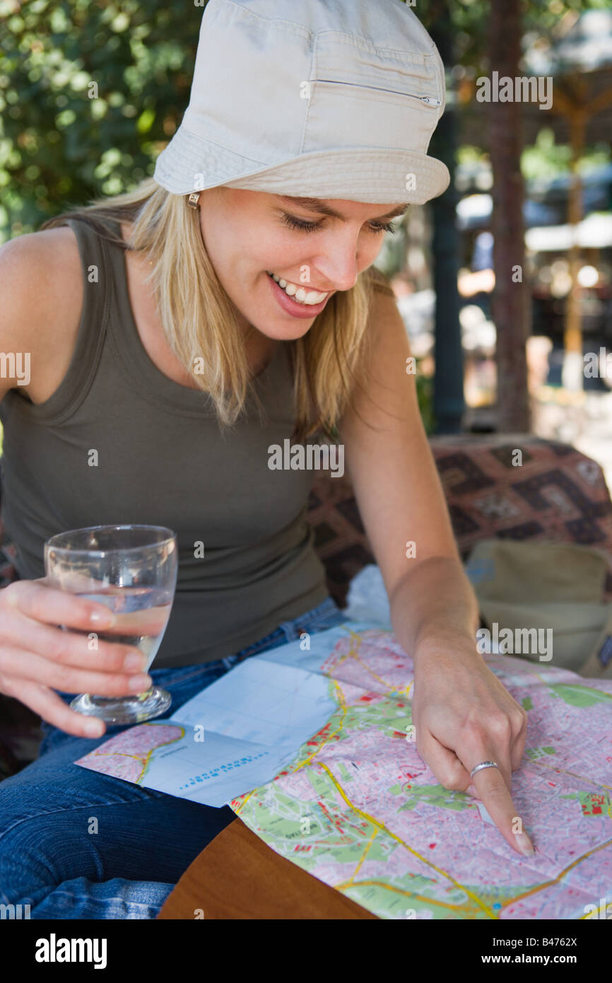 Young woman looking at map Stock Photo - Alamy