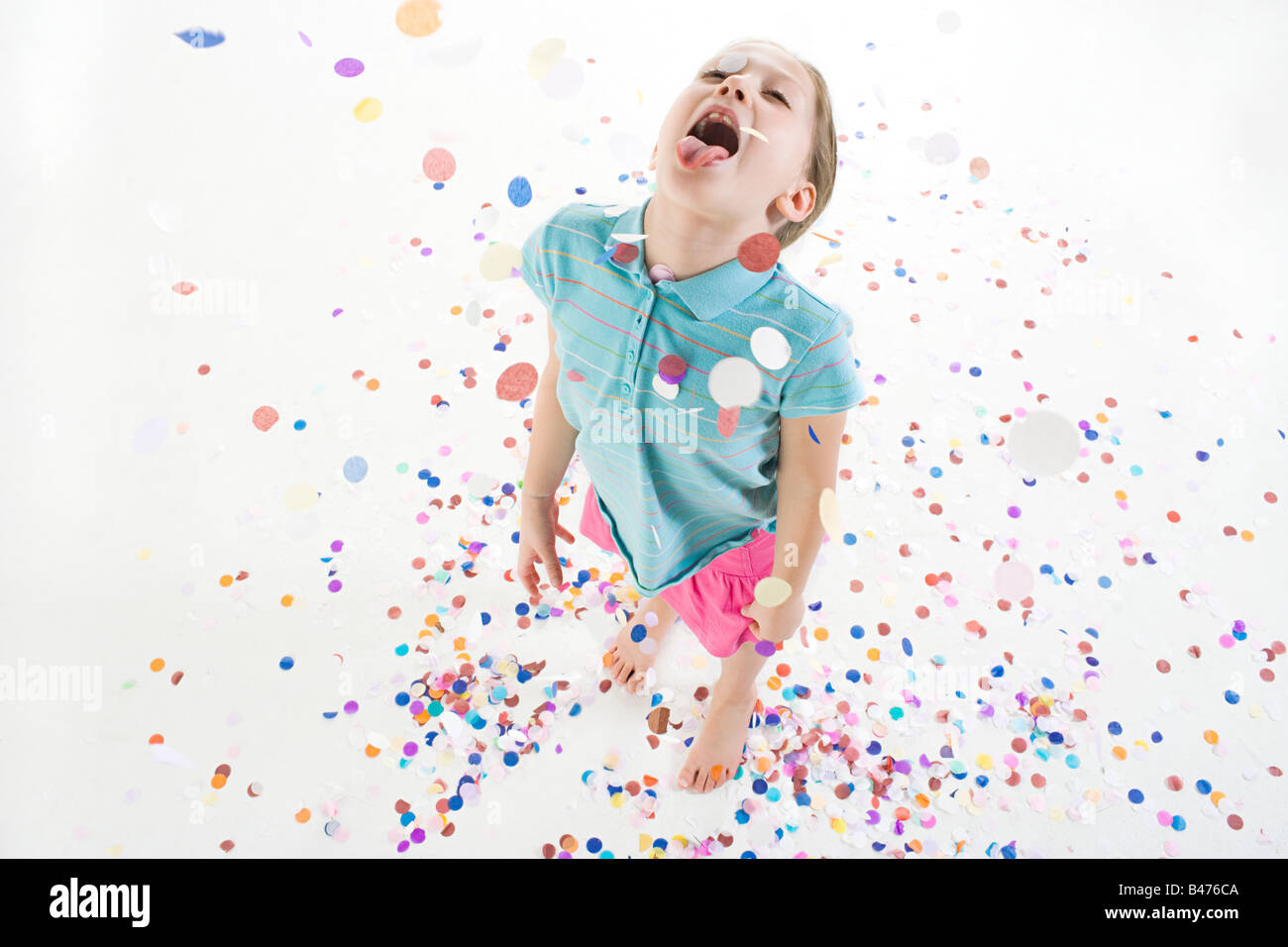 A girl playing in confetti Stock Photo - Alamy