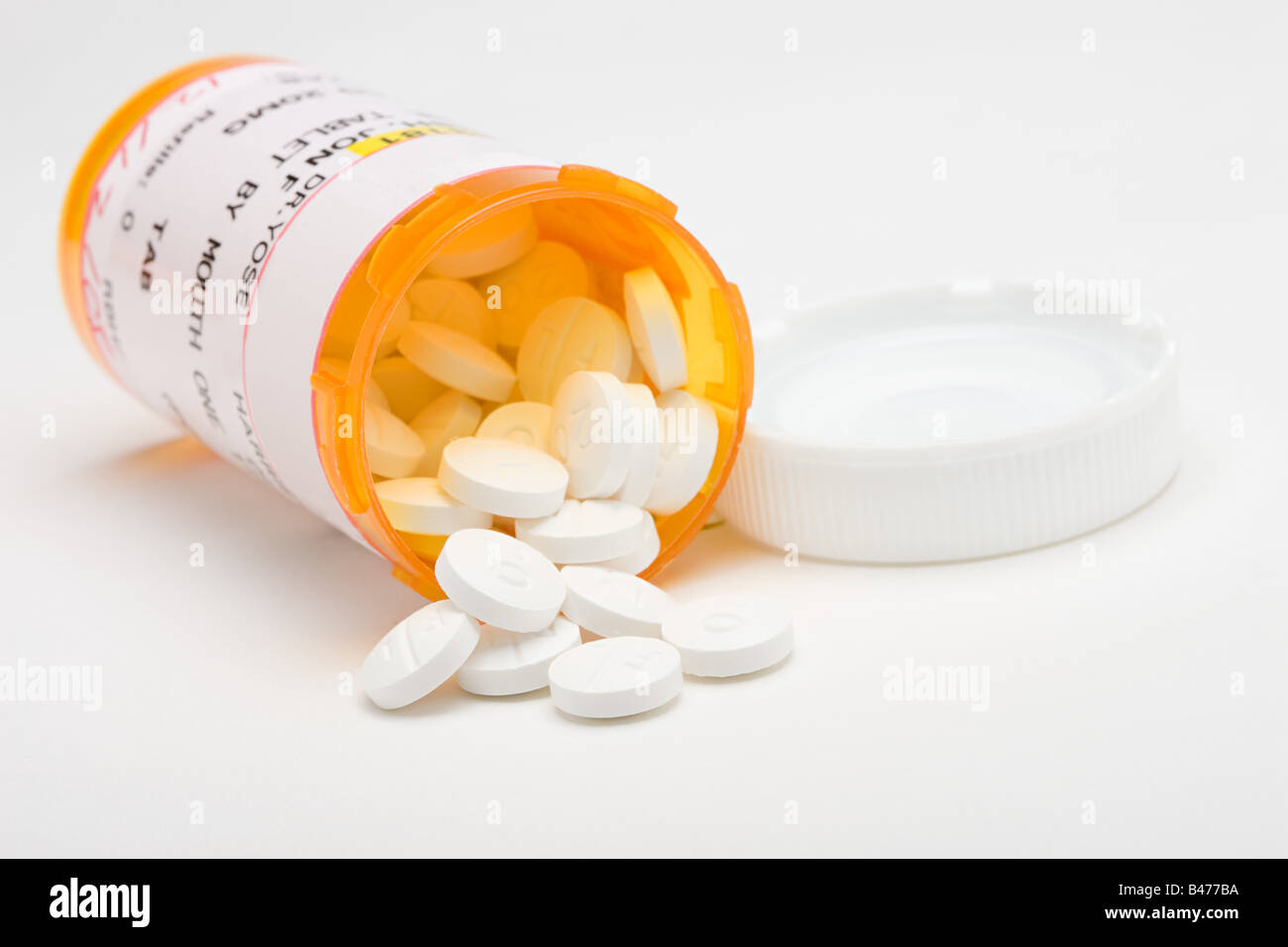 Tablets spilling out of a bottle Stock Photo - Alamy