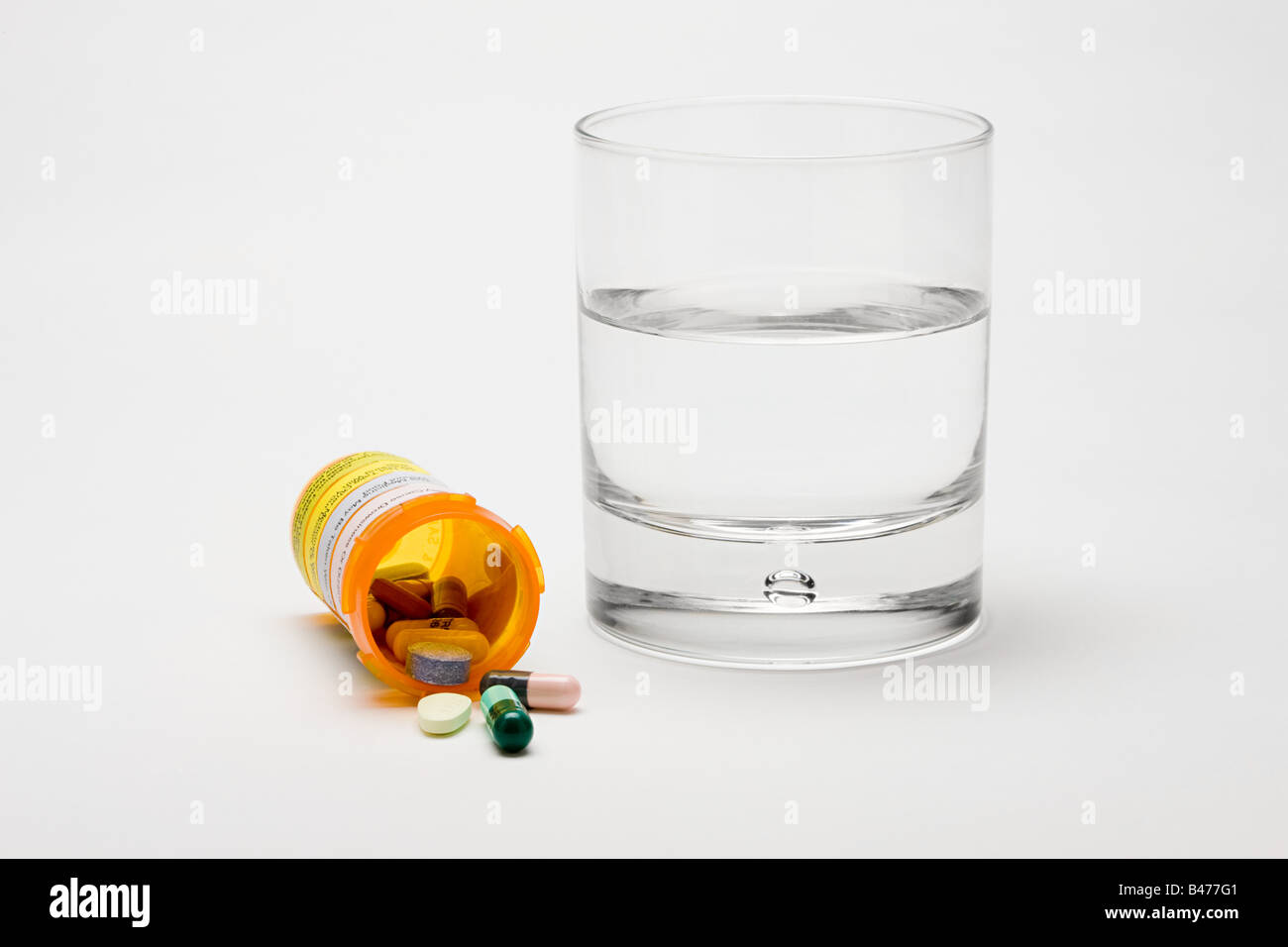 Tablets and a glass of water Stock Photo - Alamy