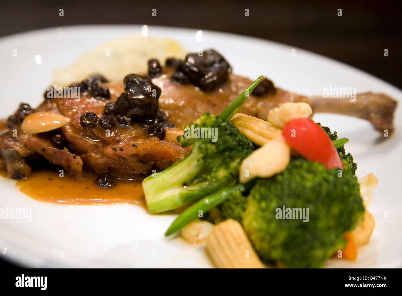 Honey glazed roasted duck leg with dried fruit Stock Photo - Alamy