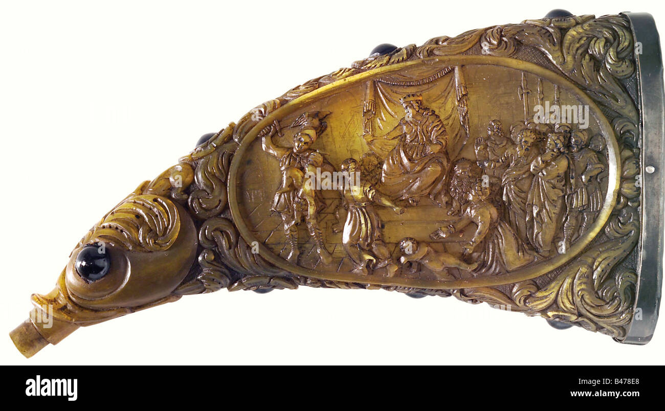 A carved powder horn, German, mid-18th century. The body is of greenish ...