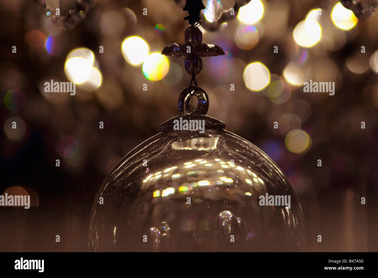 A crystal ball drop at the end of a chandelier in an elegant entrance ...