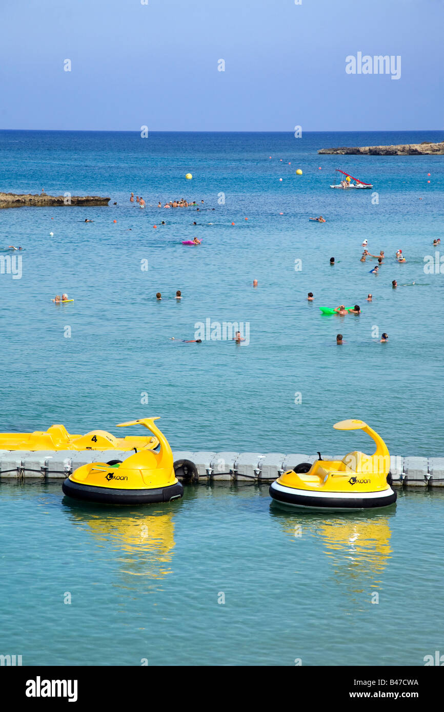 VIEW OF FIG TREE BAY, PROTARAS, IN CYPRUS WITH PEOPLE SWIMMING AND FUN ...