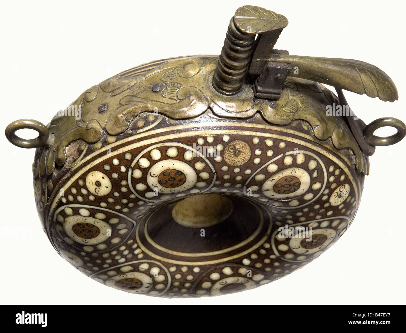 A German priming flask, circa 1580. Ring shaped walnut body richly ...