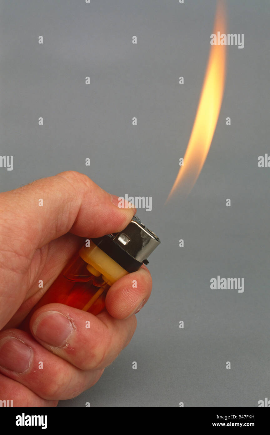 Person lighting disposable lighter Grey background LIGHTER Stock Photo ...