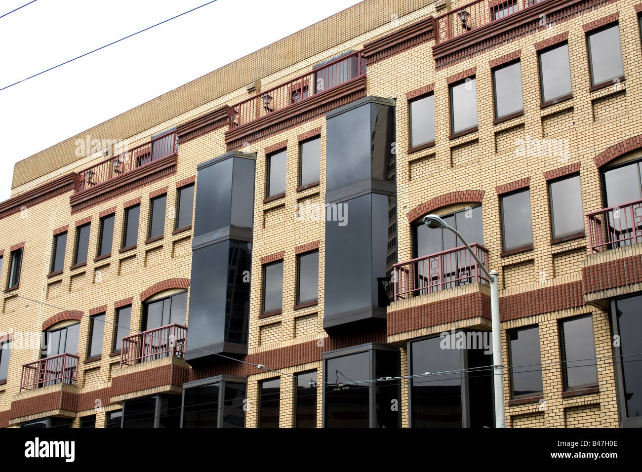 Front face of a building with many glass windows Stock Photo - Alamy
