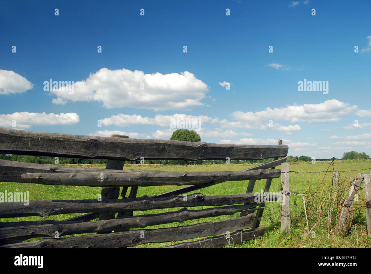 Barbed wire fence and wooden gate on polish countryside Stock Photo - Alamy
