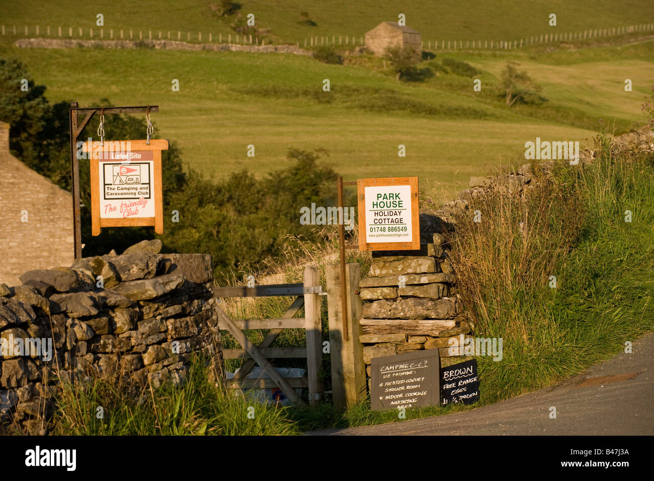Signs at farm road end for caravaning camping and produce for sale ...