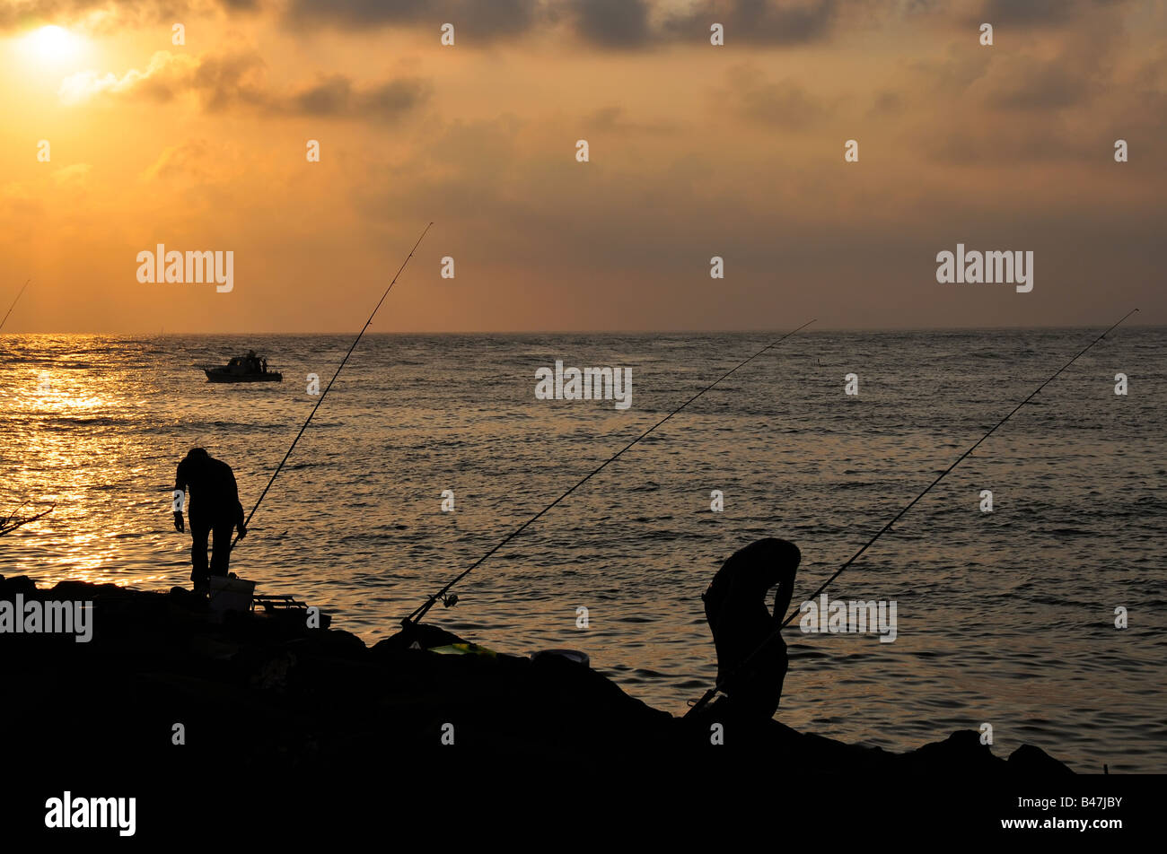 fishing on the sea at sunset Stock Photo - Alamy