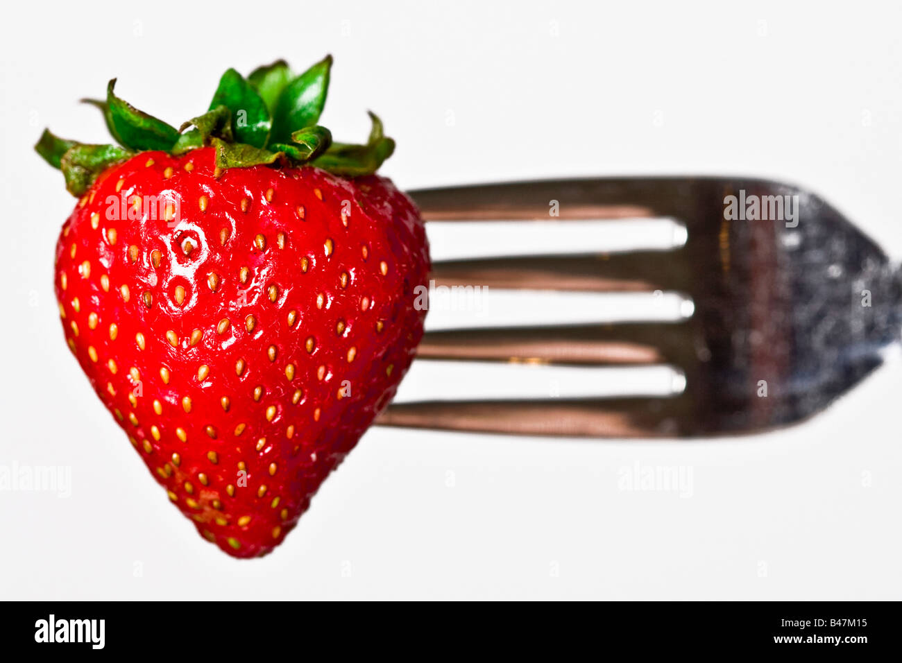 Strawberry on a fork Stock Photo - Alamy
