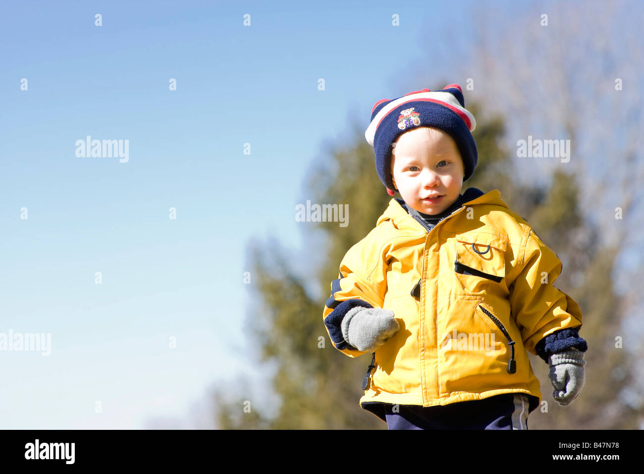 Boy outside walking on hillside Stock Photo - Alamy
