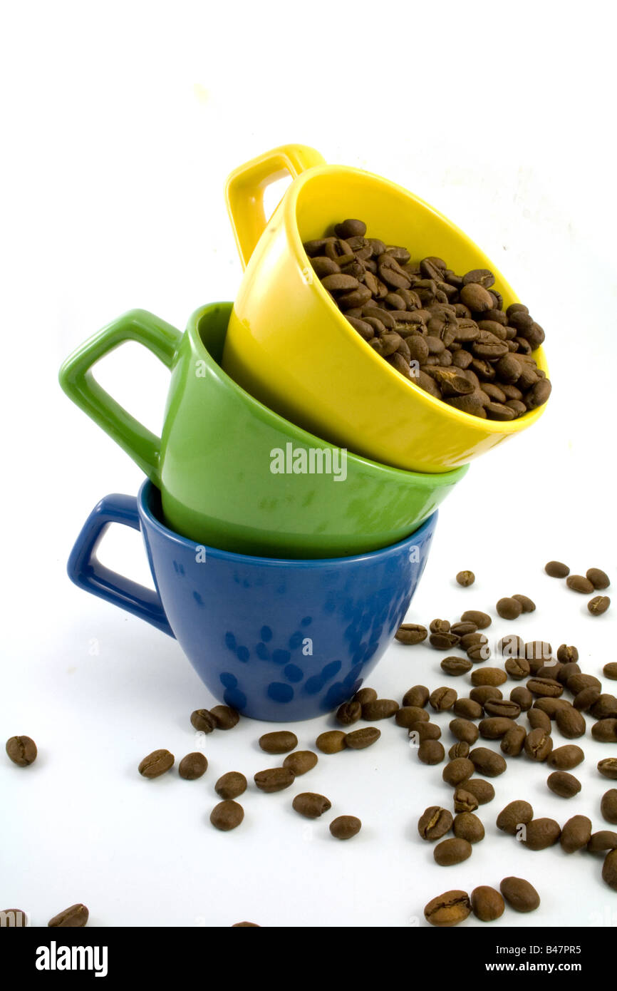 three cups with beans isolated on white Stock Photo - Alamy