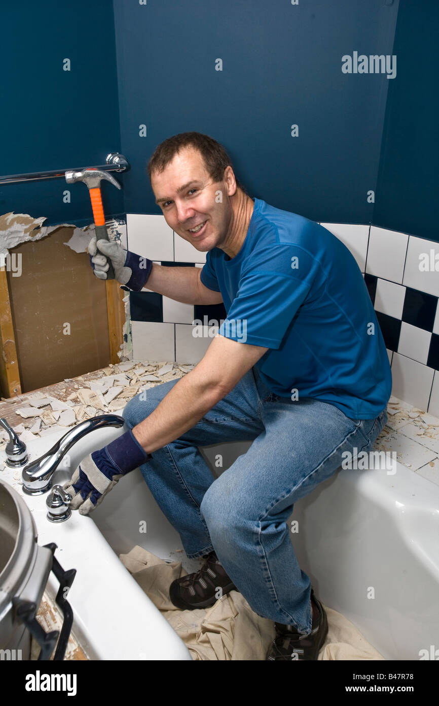 Man fixing bathroom tiles Stock Photo - Alamy