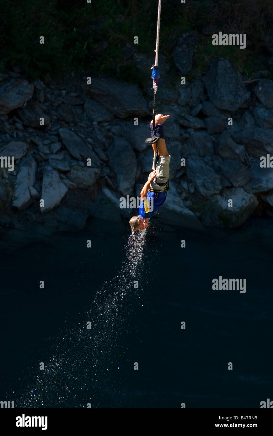 A man bungee jumping emerging from the water from the A J Hackett ...