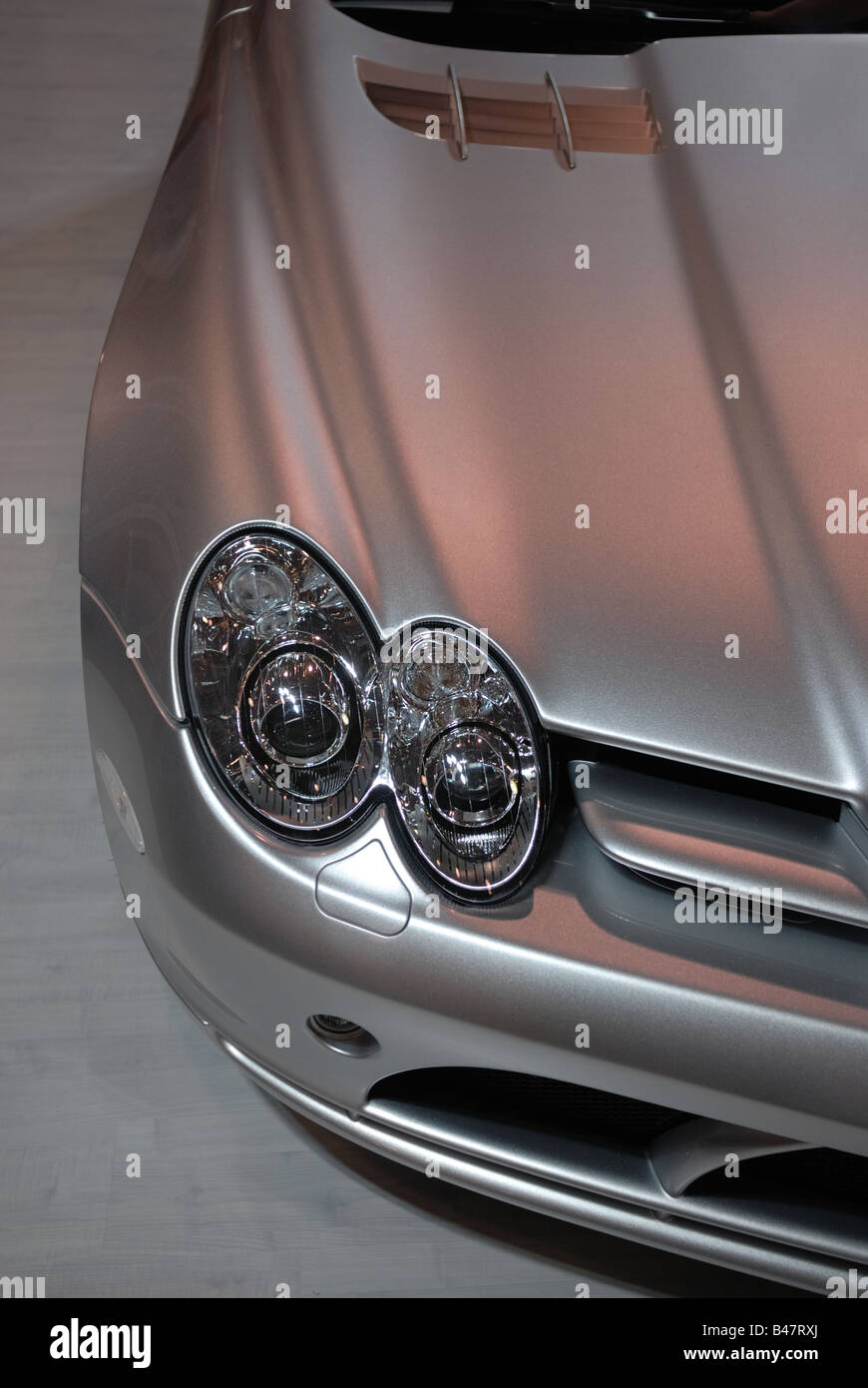 Front section of a silver luxury car, hood and headlights Stock Photo ...