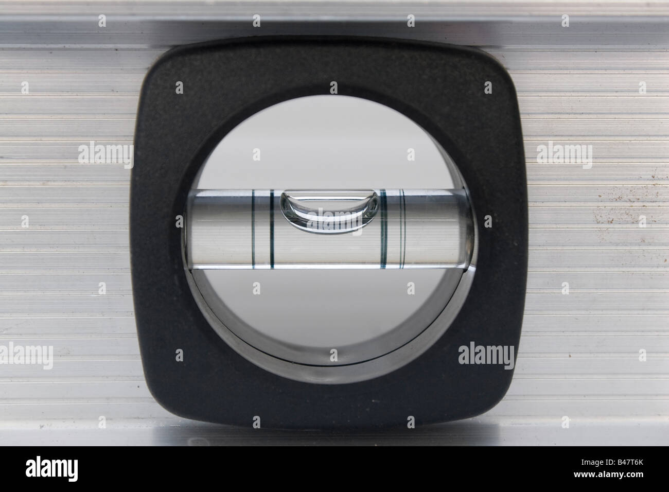 A closeup of a carpenters bubble level with a brushed aluminum finish ...