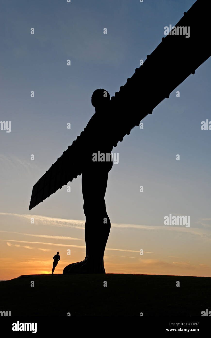 Wide-angle picture at dusk of a lone runner rounding the Angel of the ...