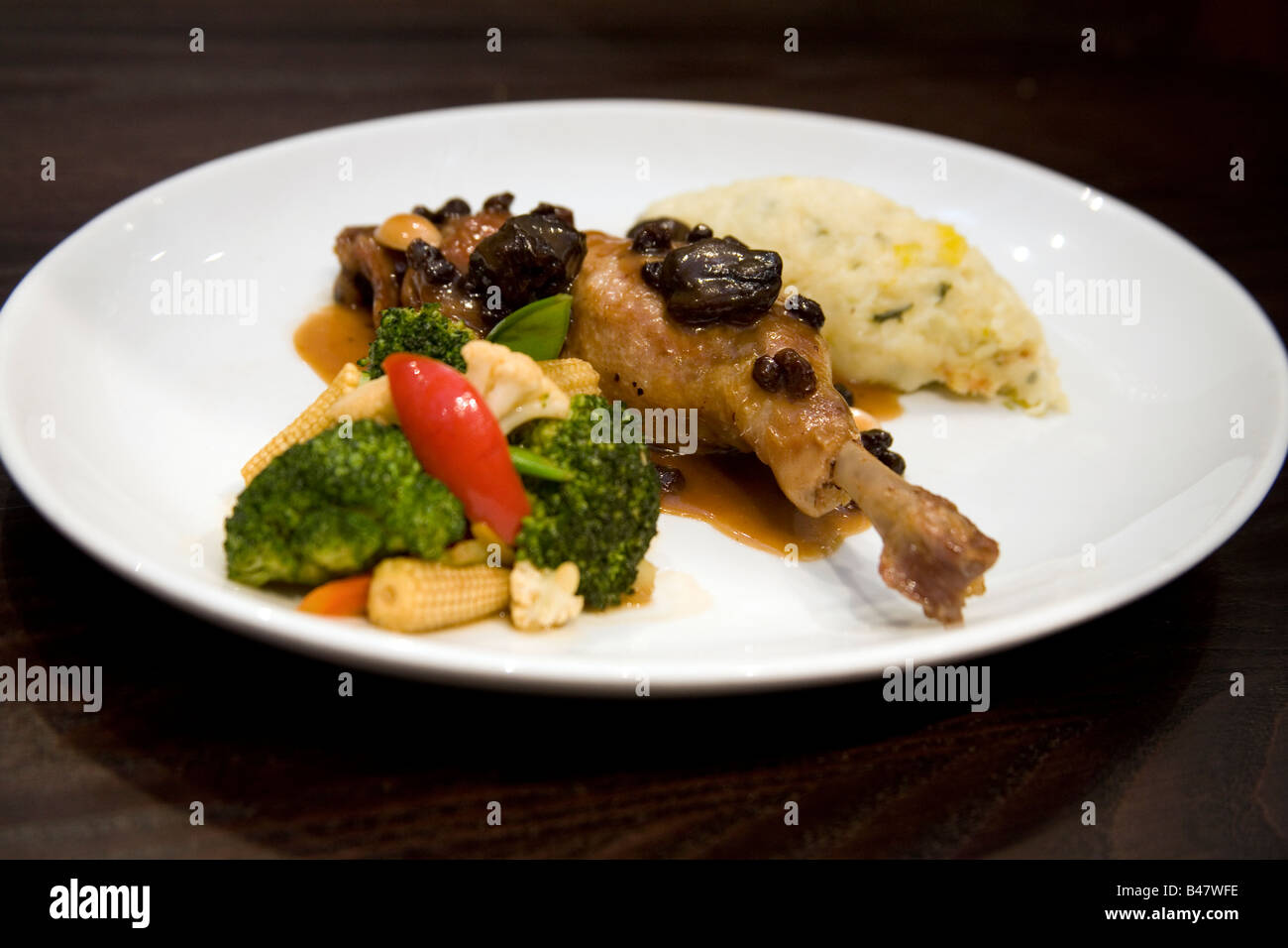 Honey glazed roasted duck leg with dried fruit Stock Photo - Alamy