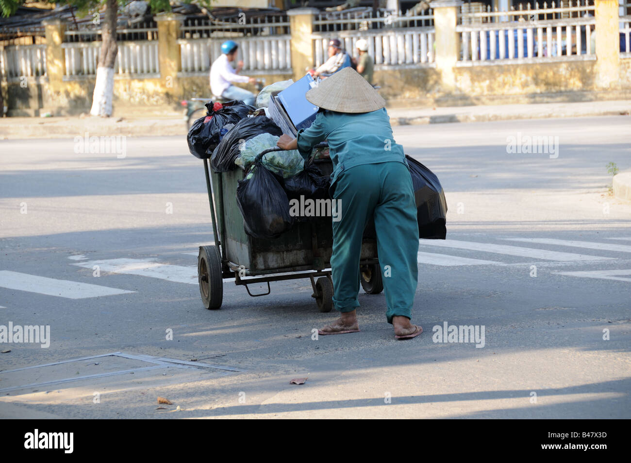 Vietnamese woman pushing a refuse cart Hue Vietnam Stock Photo - Alamy